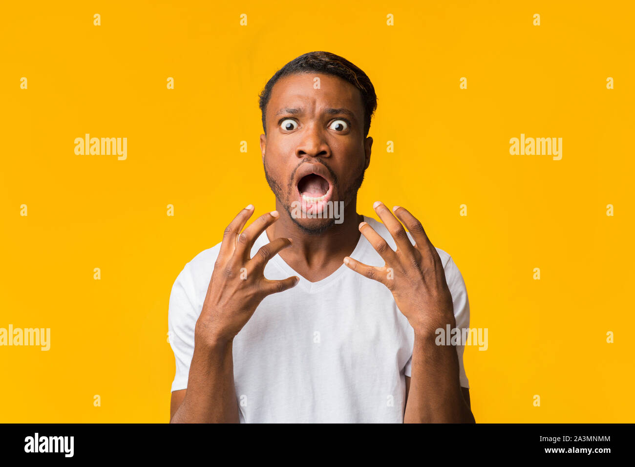 Frightened Black Man Screaming Looking At Camera Standing In Studio ...