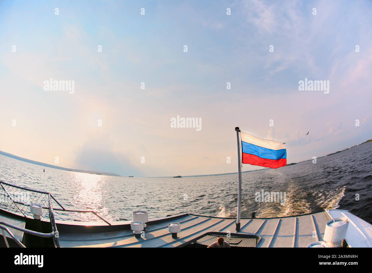 Russian flag waving in the wind on the background of water and sky ...