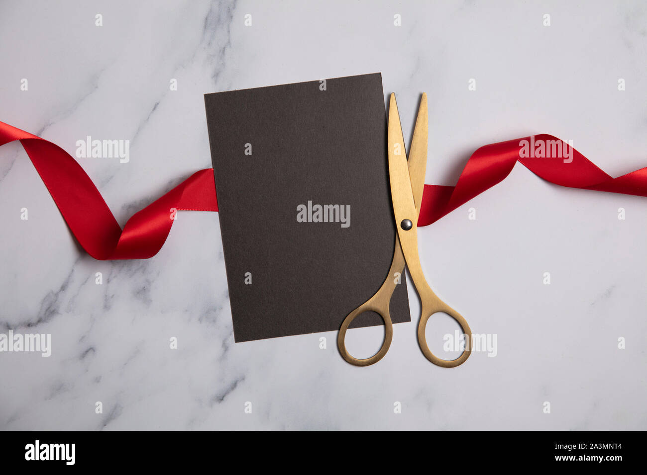 Grand opening background. Gold scissors with red ribbon on a marble ...