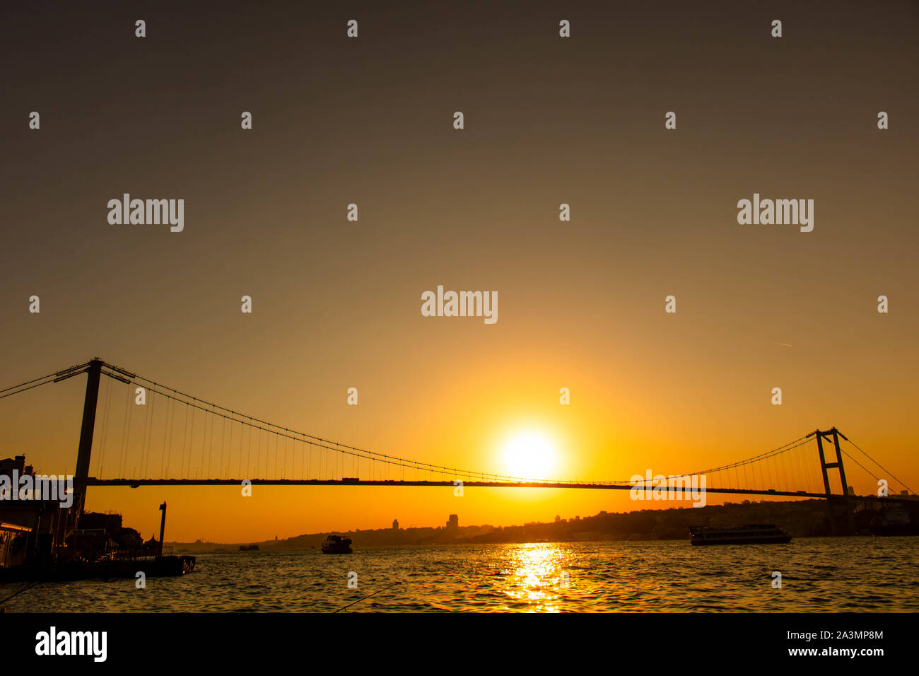 Skyline and city bridge with the sun and the sea hi-res stock ...