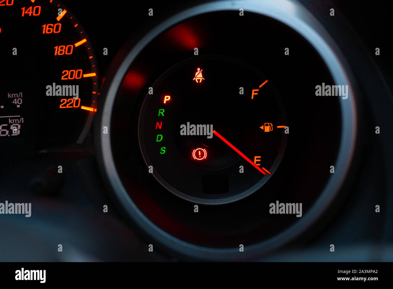 Close up of meter panel with the needle pointing at E on black ...