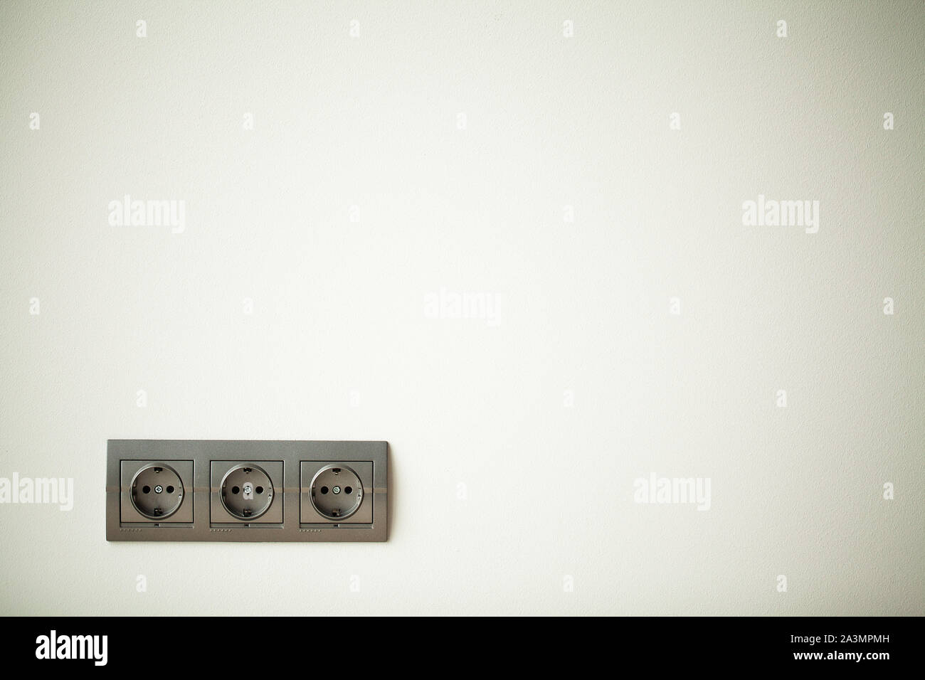 Closeup view of a group of gray european electrical outlets located on ...