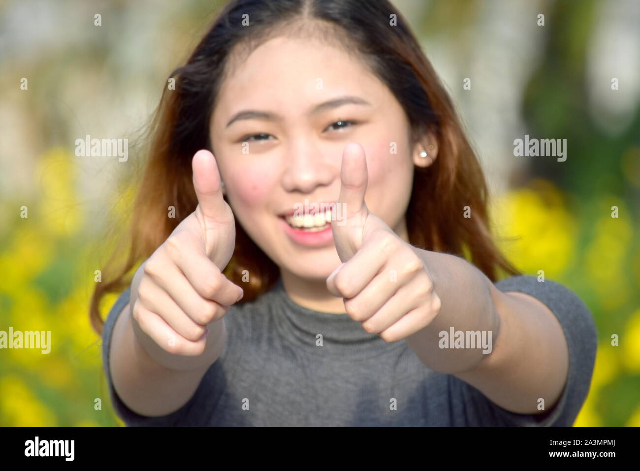 Beautiful young woman thumb hi-res stock photography and images - Alamy