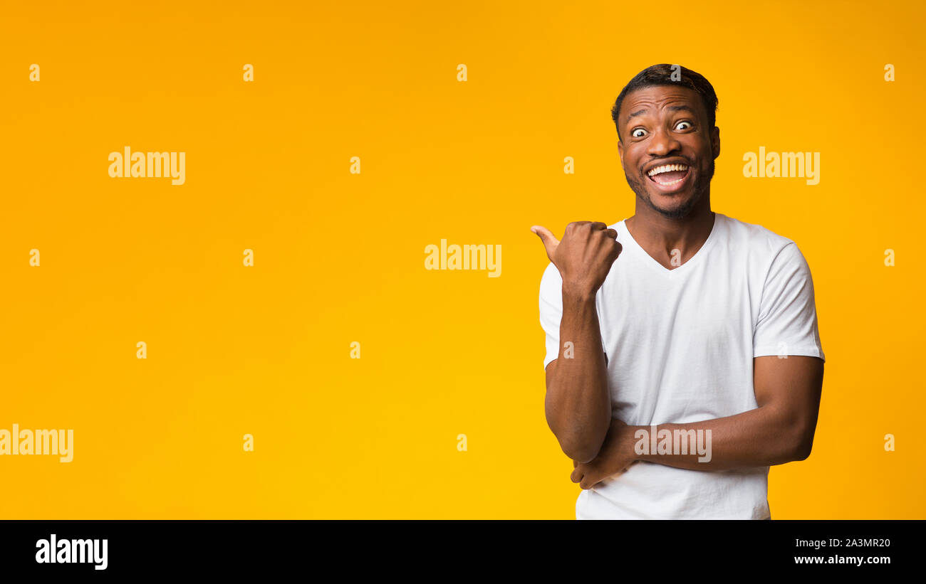 Funny Man Pointing Thumbs At Free Space, Yellow Background, Panorama ...
