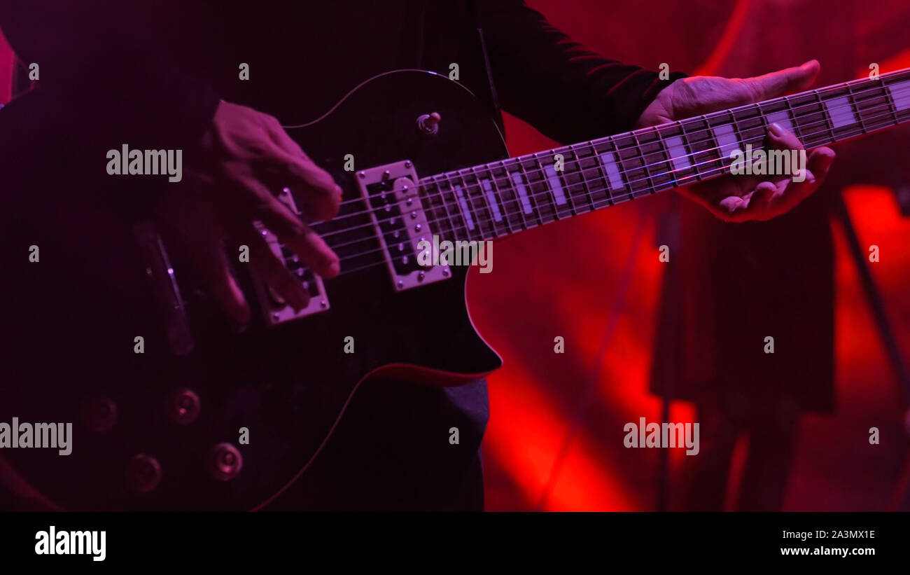 Guitar player on stage Stock Photo - Alamy