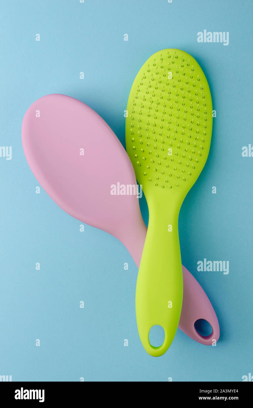 Hair care products. Colorful Hair combs for scalp massage on blue ...