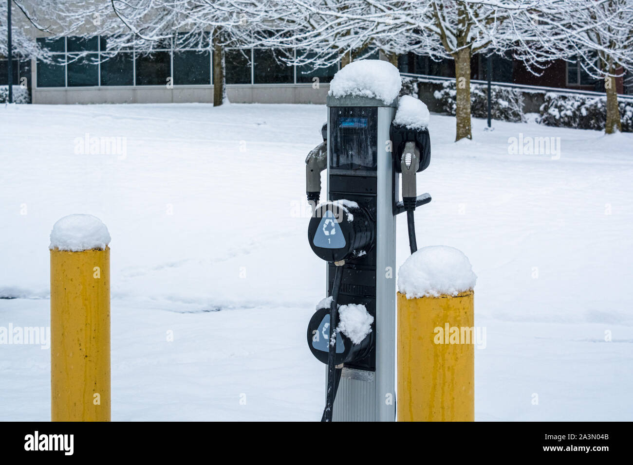 EV charging station for zero emission cars on white snow background ...