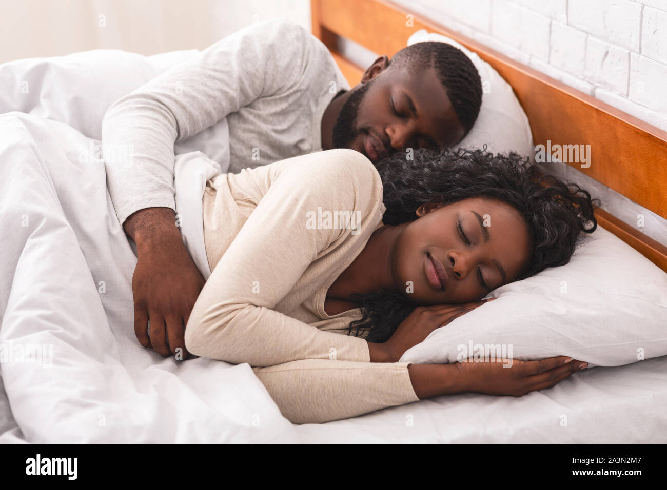 Young african american couple napping in bed together Stock Photo - Alamy