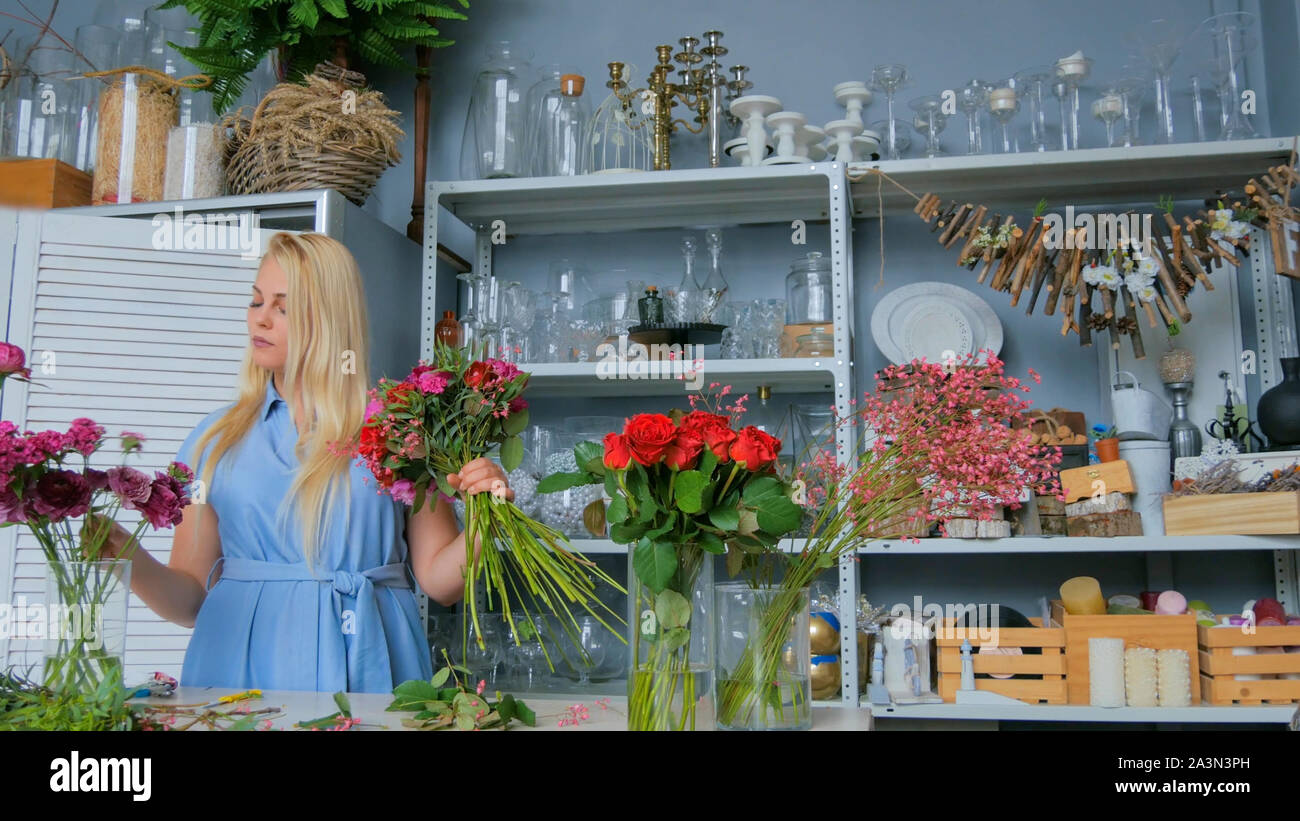 Professional florist making beautiful bouquet at flower store Stock Photo - Alamy
