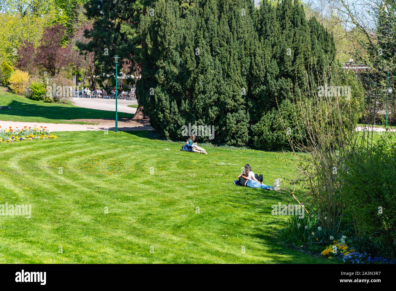 Couple enjoying spring sun in Parque de la Pépinière in Nancy, France ...