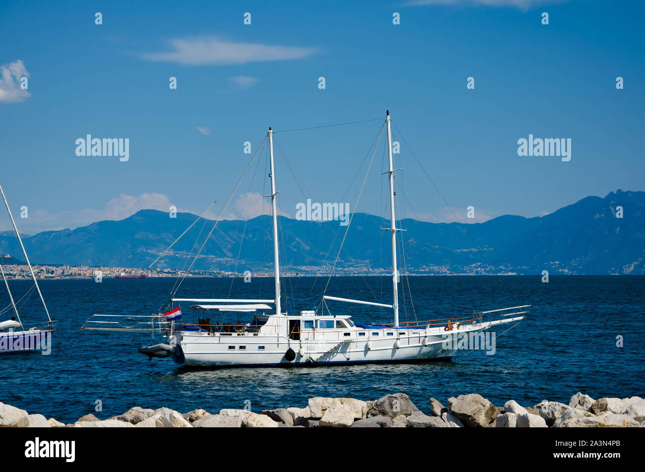Sail boat on mountains background on the gulf of Naples in Italy ...