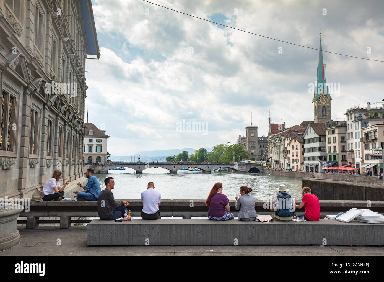 People relaxing at lunch break at Limmat river in Zurich , Switzerland ...