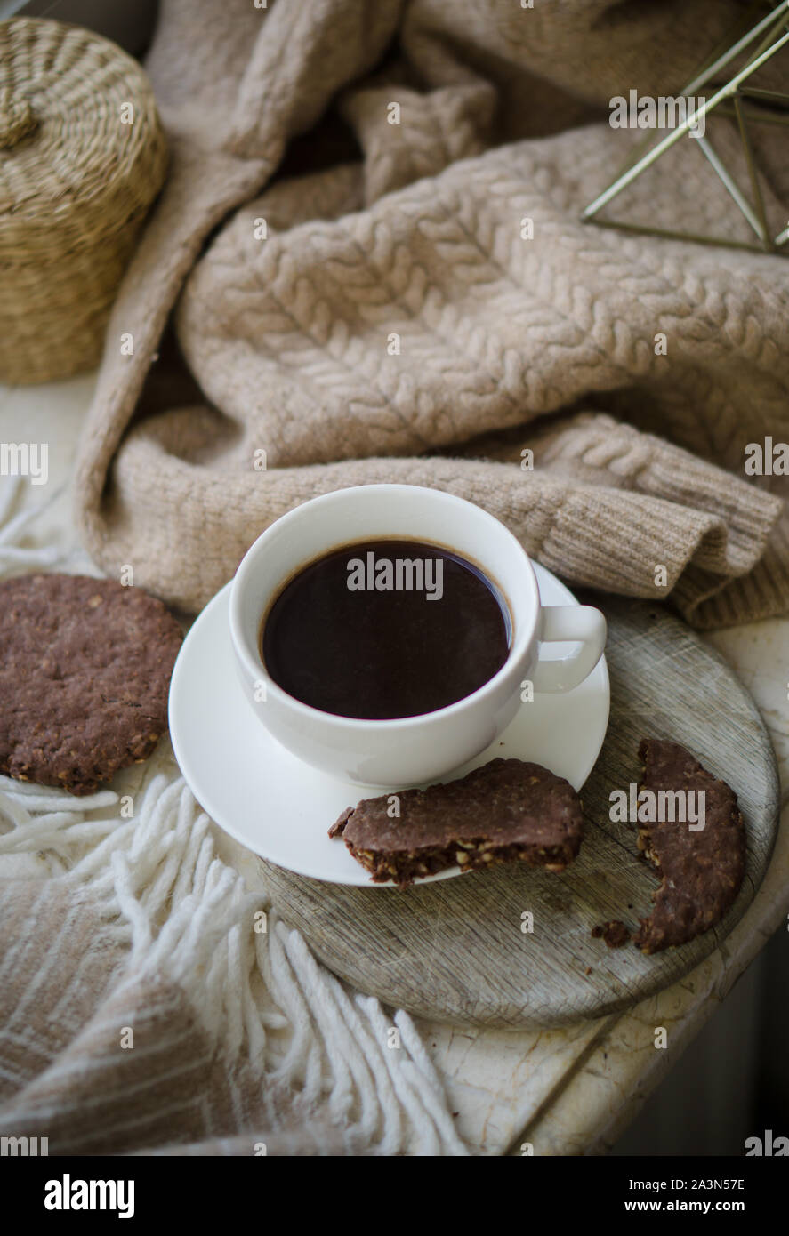 Cup of coffe with milk and chocolate cookies on warm wool blanket Stock ...