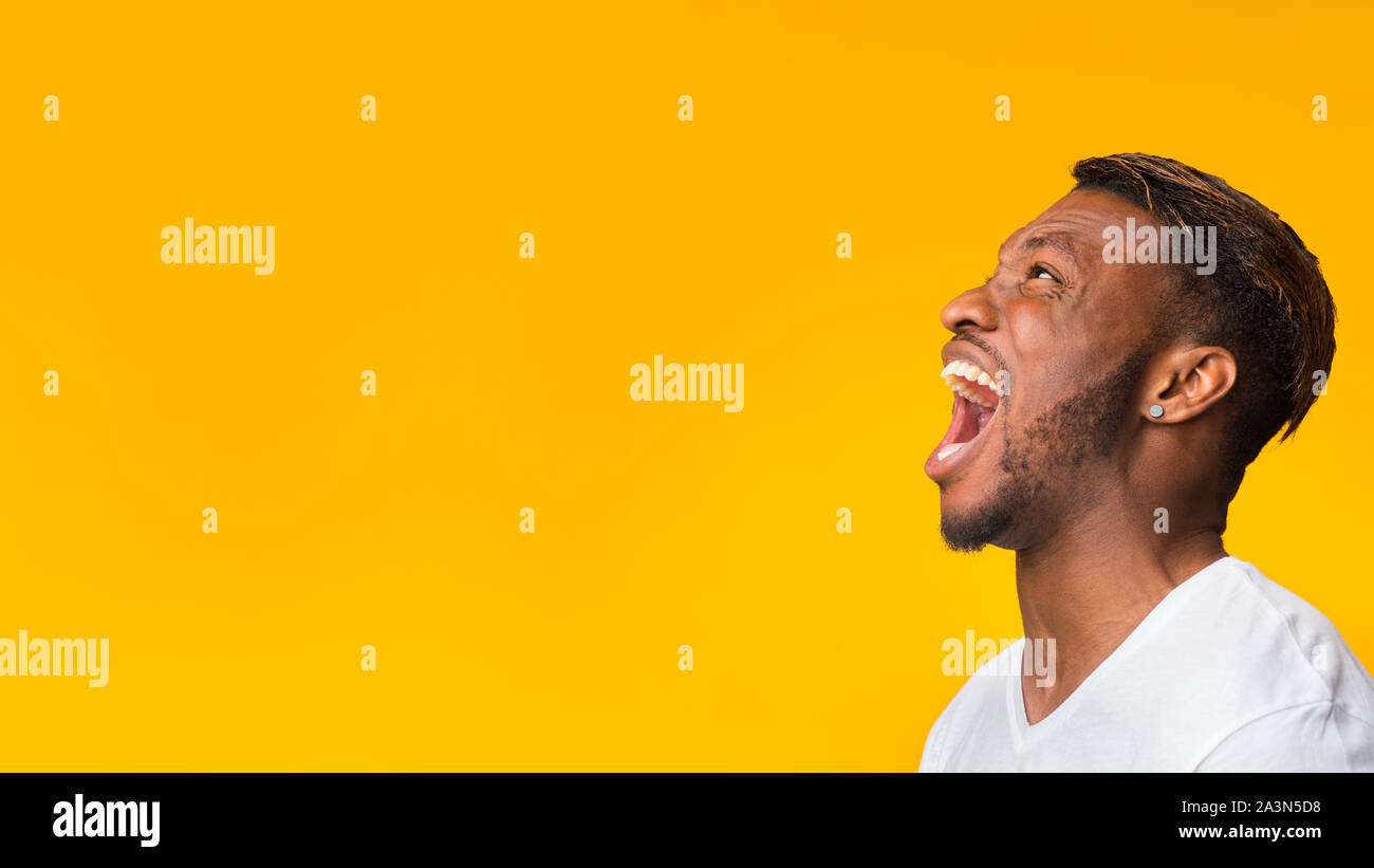 Black Guy Screaming Loudly Standing In Studio, Panorama, Side View ...