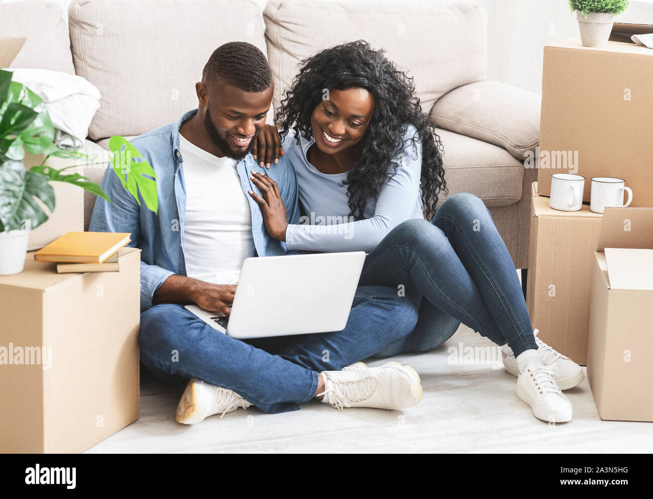 Just married couple making shopping online at new house Stock Photo - Alamy