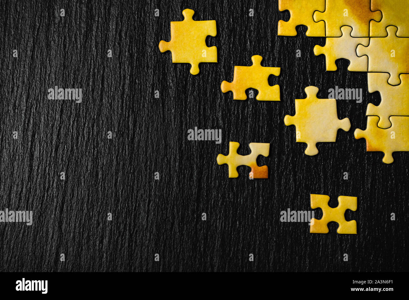 Yellow puzzle on a black stone background. Frame from puzzle around ...