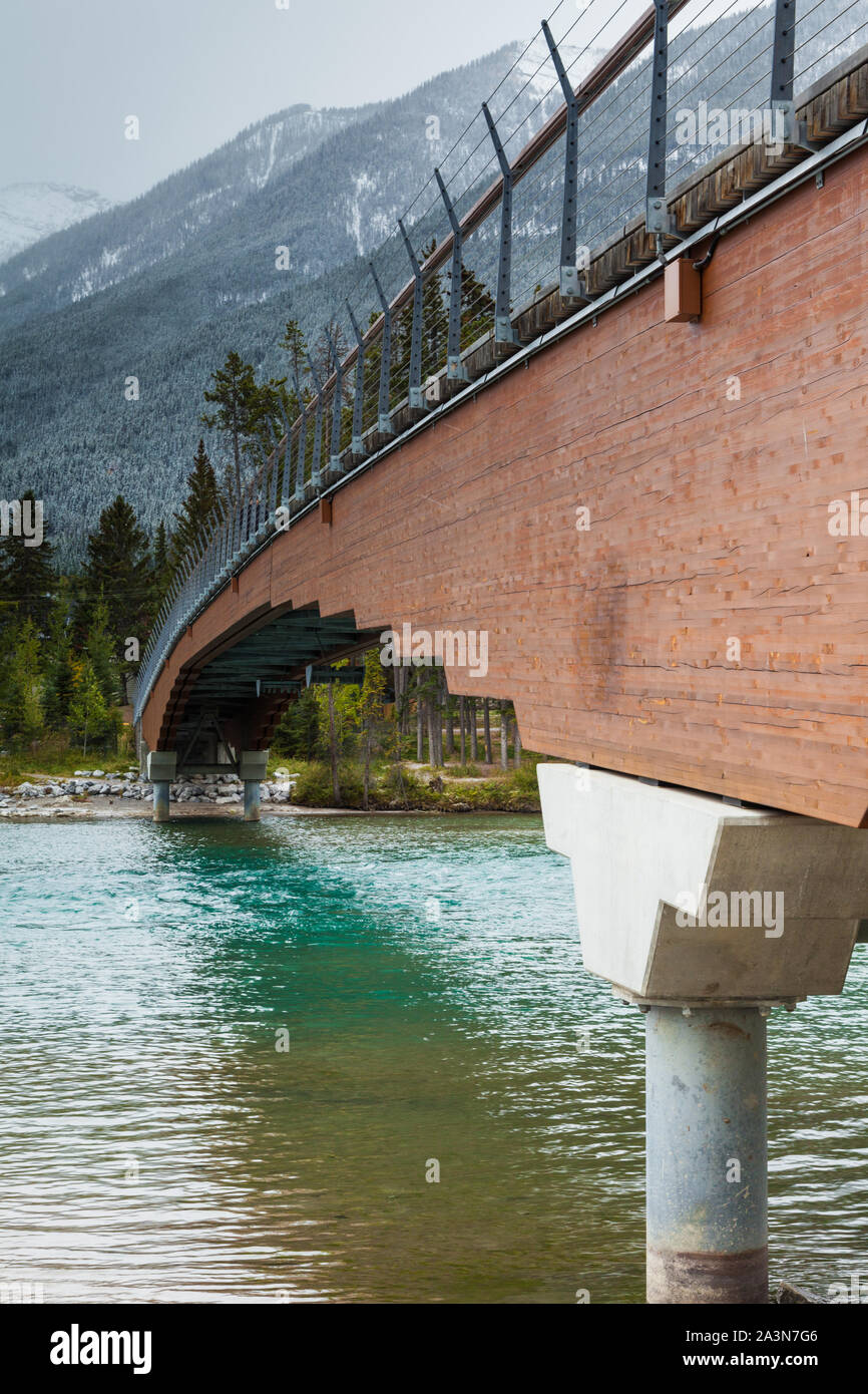 Footbridge across the Bow River in the mountain town of Banff Alberta ...
