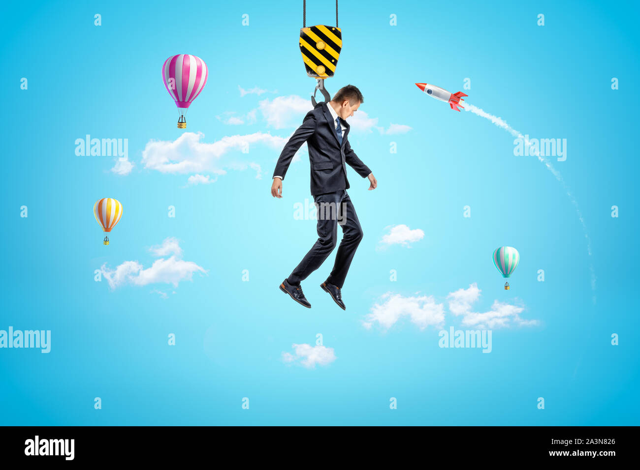 Businessman hanging on construction crane hook with hot air balloons ...