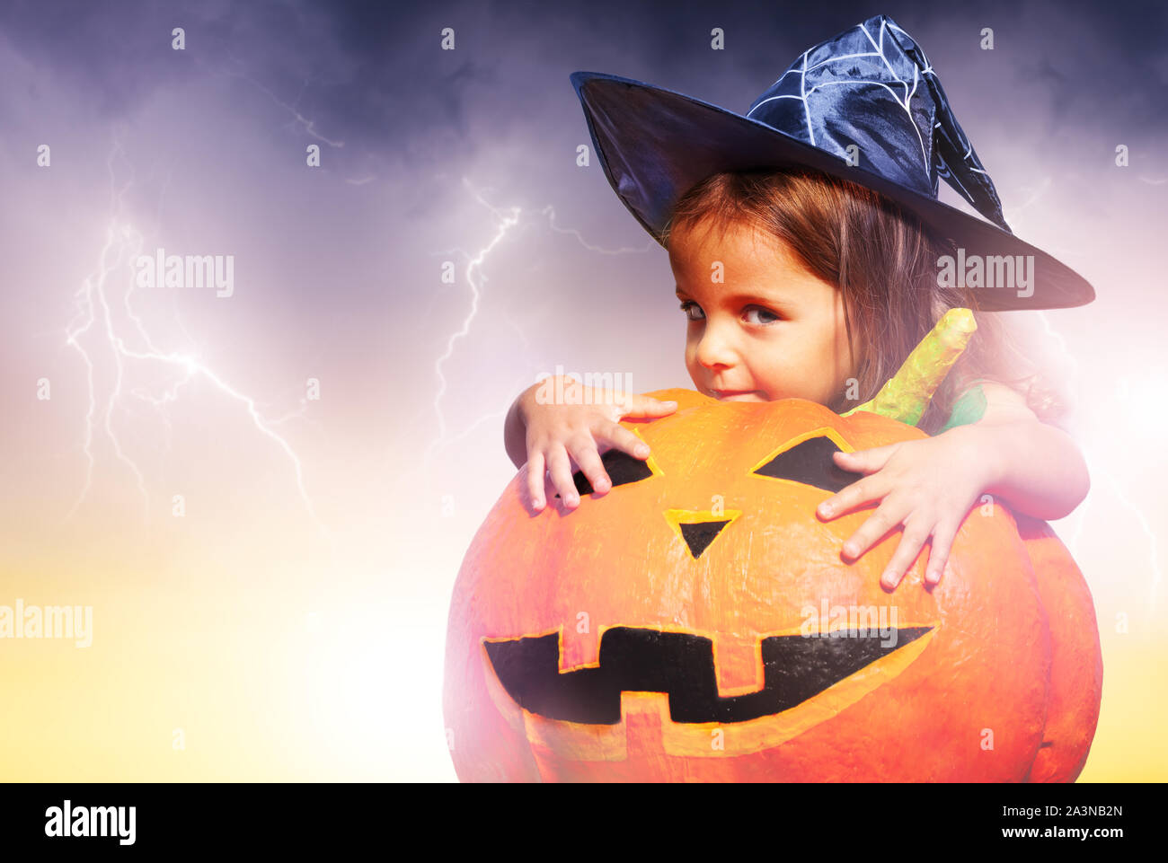 Girl expression in Halloween costume hug pumpkin Stock Photo - Alamy