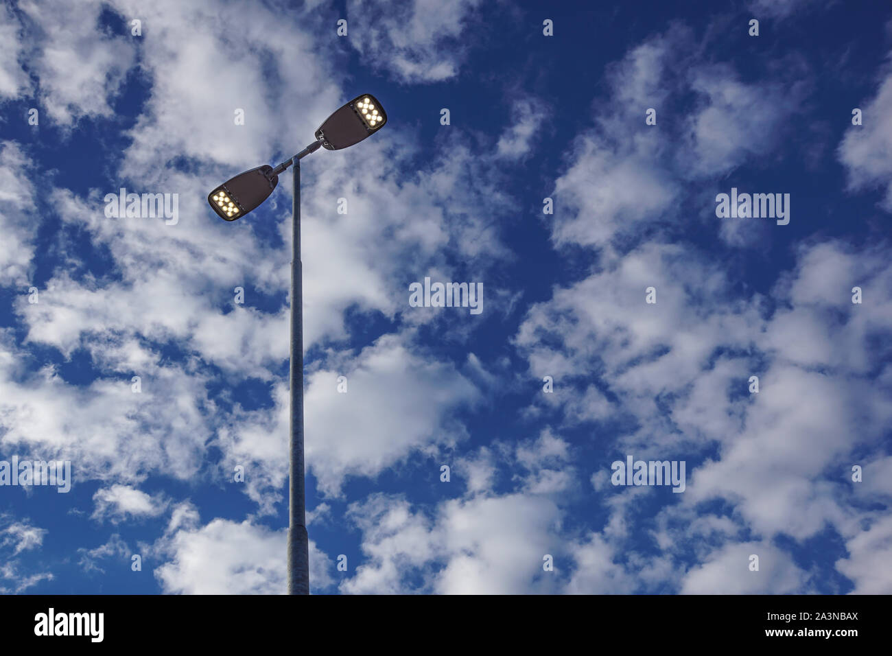 Electricity Lighting Lamp Pole Beside Road with Blue Sky and White ...