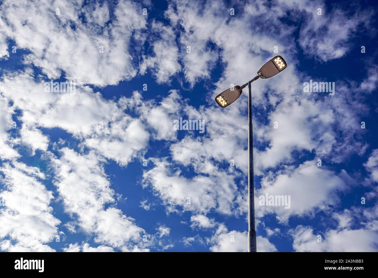 Electricity Lighting Lamp Pole Beside Road with Blue Sky and White ...