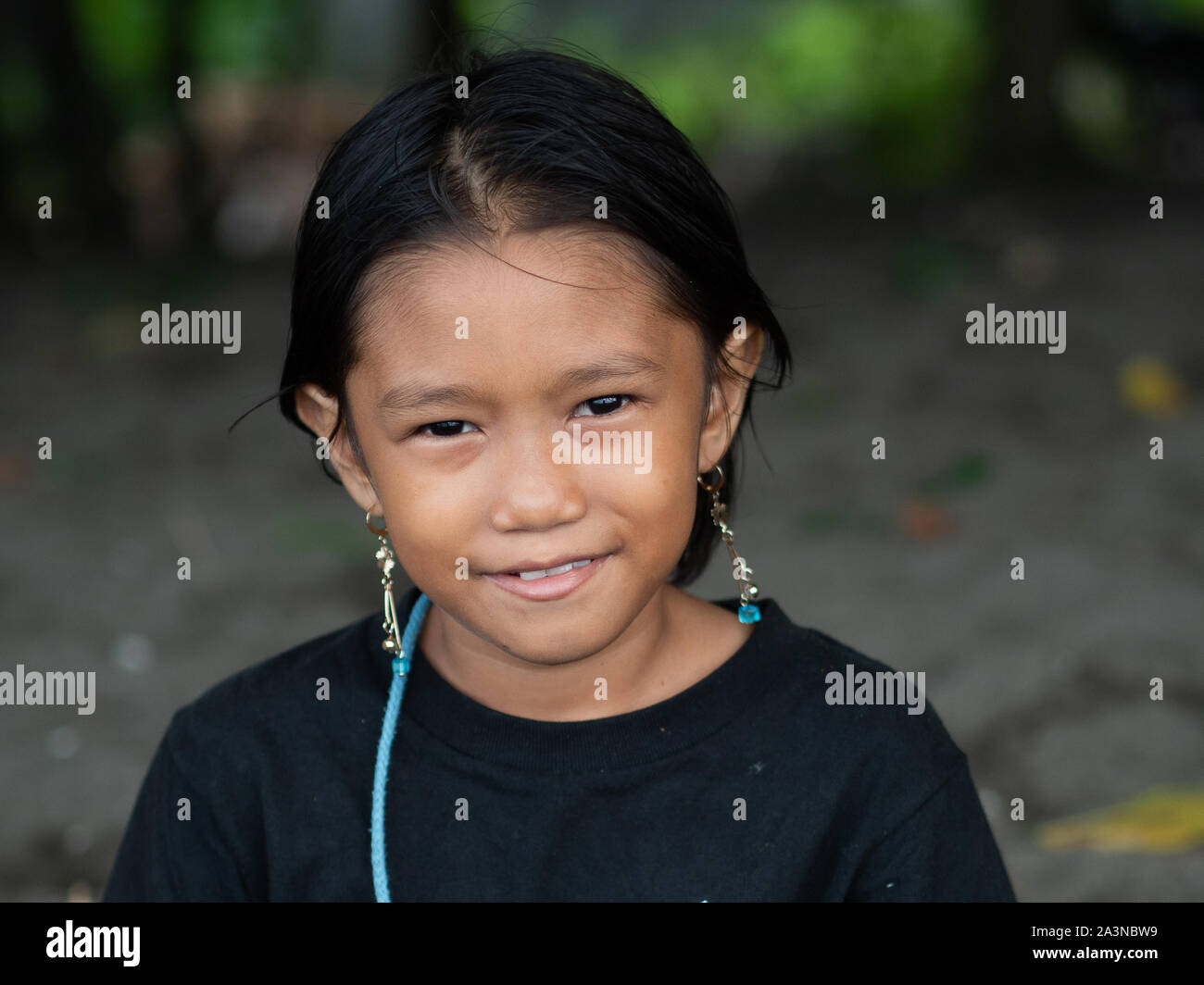 Young girl looking at the camera smiling Stock Photo - Alamy