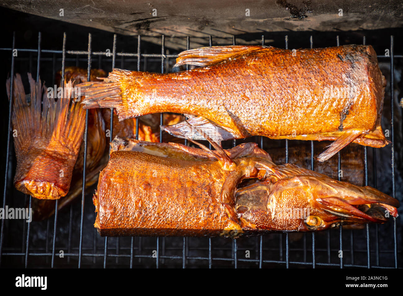 Closeup of fish pike smoke in smokehouse made of old traditional ...