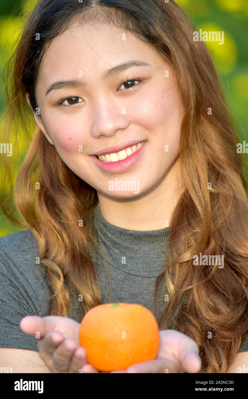 Filipina Female Smiling With Fruit Stock Photo - Alamy