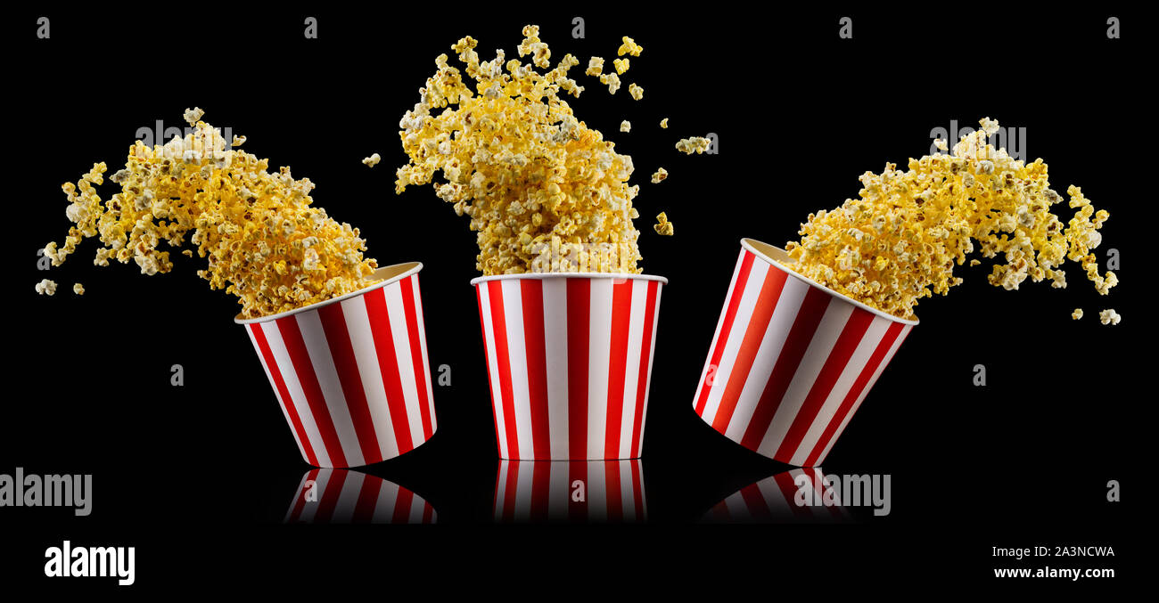 Set of paper striped buckets with popcorn isolated on black background ...