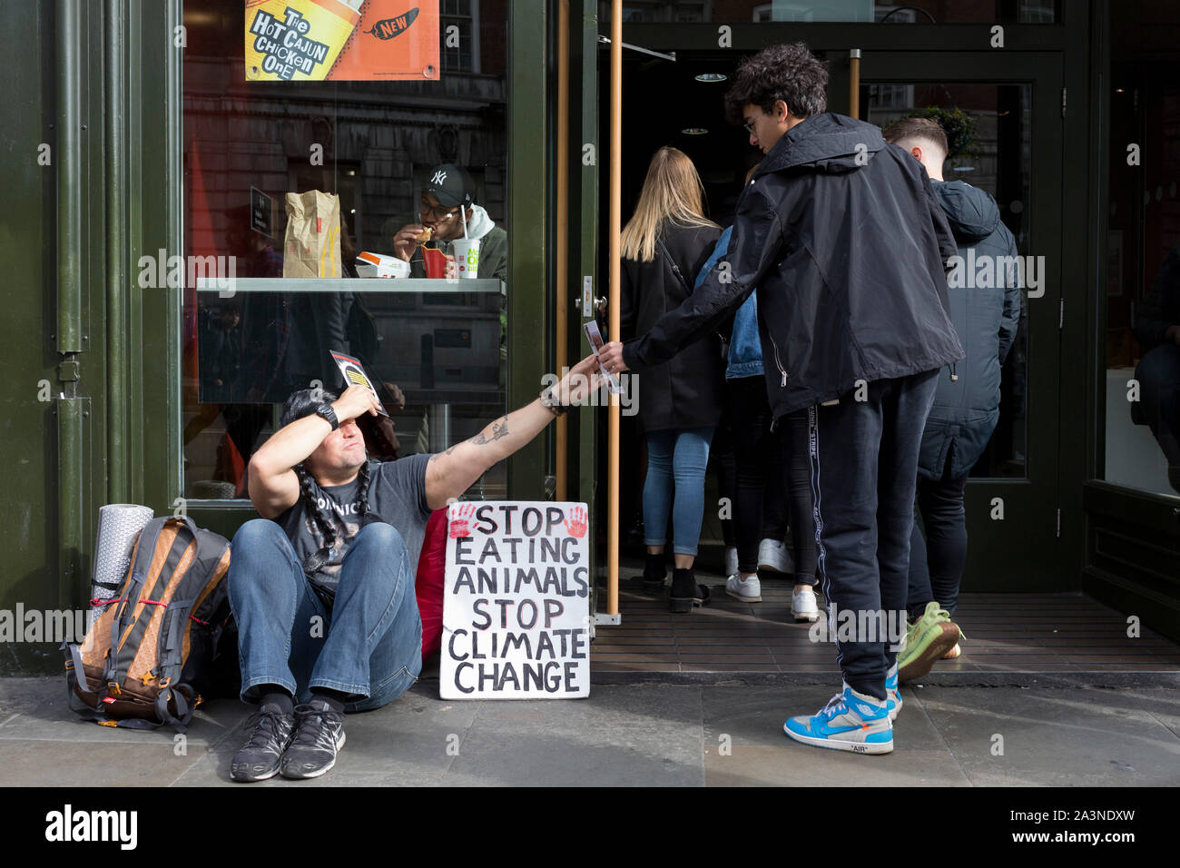 A food science protester sits outside a McDonalds restaurant in ...