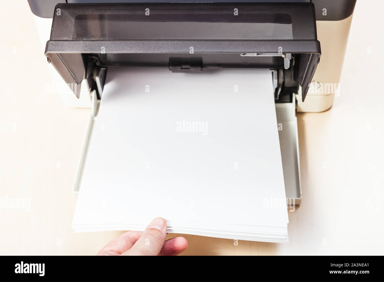 putting of white paper sheets in printer tray of multi function device ...