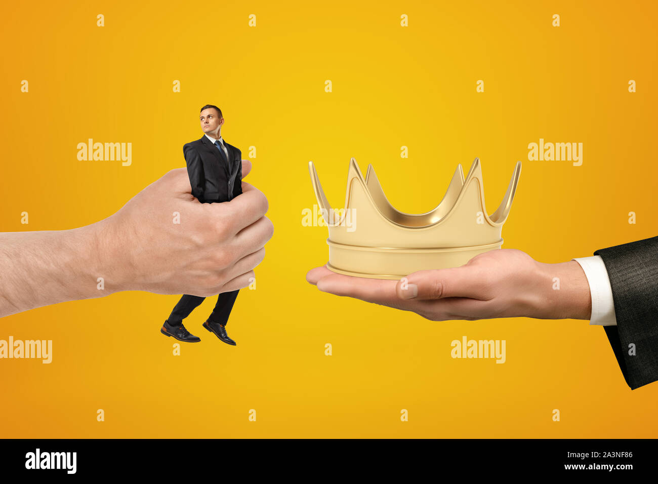 Man's hand exchanging tiny businessman for gold crown held in another ...