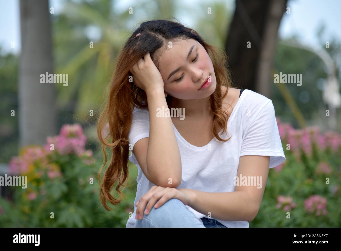 Worrisome Asian Woman Stock Photo - Alamy