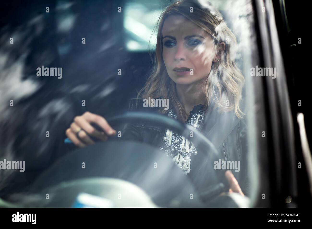 Young lady driving her car Stock Photo - Alamy