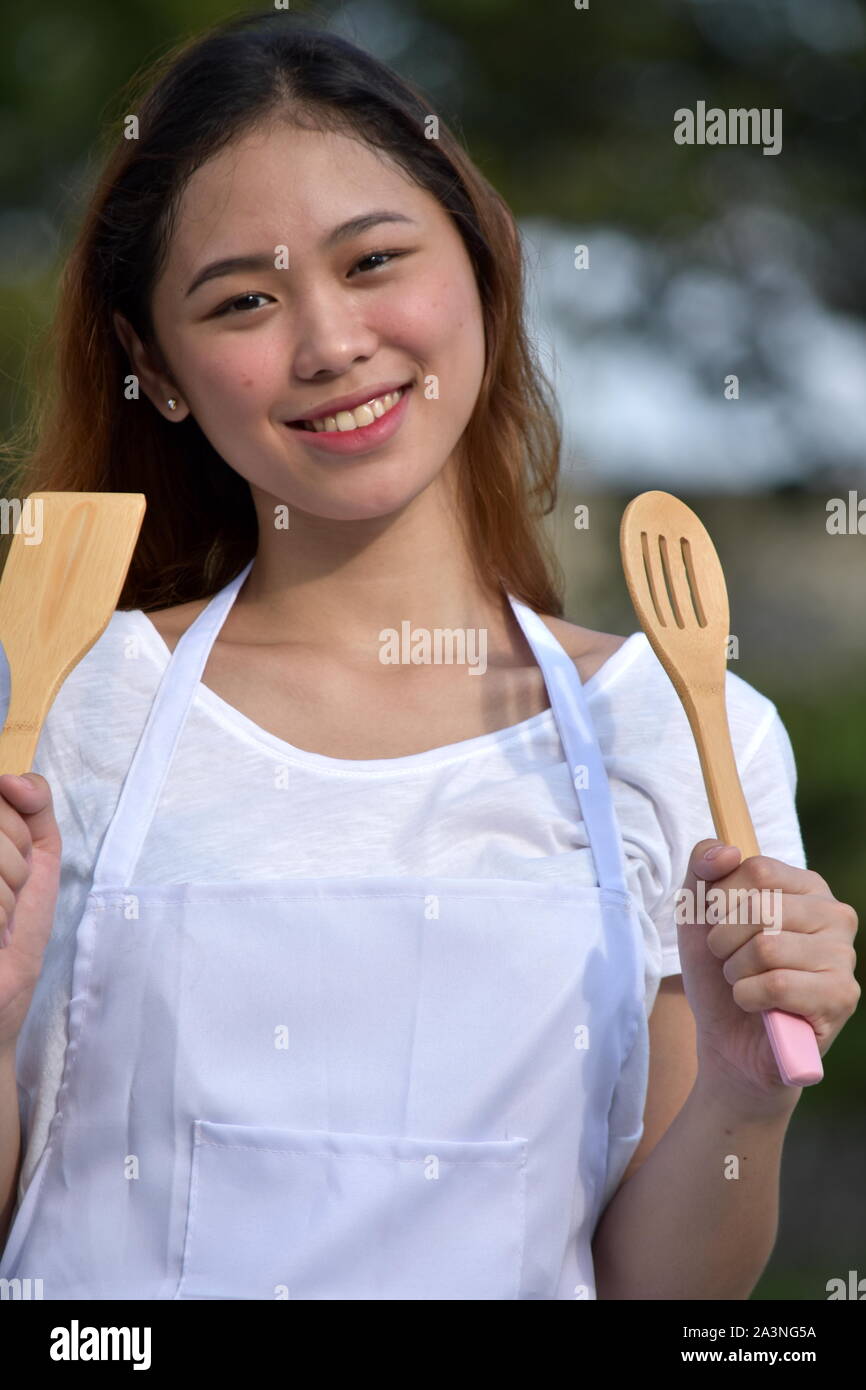 Beautiful Diverse Female Cook Smiling With Kitchen Utensils Stock Photo ...