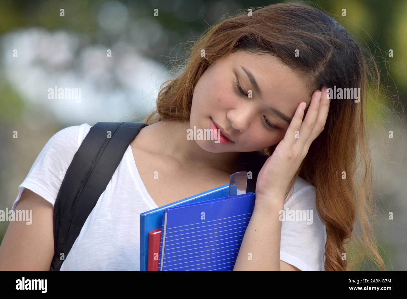 Sad Girl Student With Books Stock Photo - Alamy