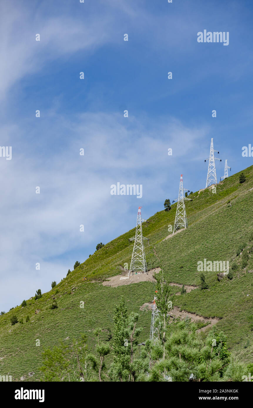 Electric transmission towers on a mountain landscape somewhere in ...