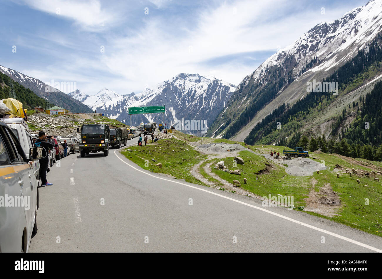 Tourist taxis patiently wait in queue as Indian Army convoy of trucks ...
