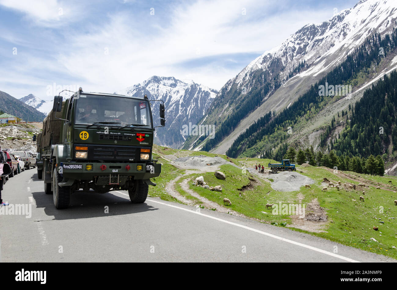 Tourist taxis patiently wait in queue as Indian Army convoy of trucks ...