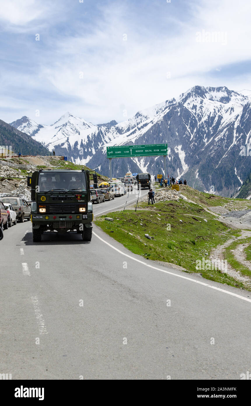 Tourist taxis patiently wait in queue as Indian Army convoy of trucks ...