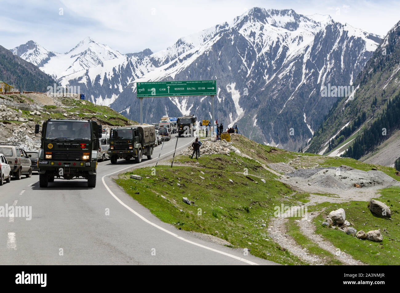 Tourist taxis patiently wait in queue as Indian Army convoy of trucks ...