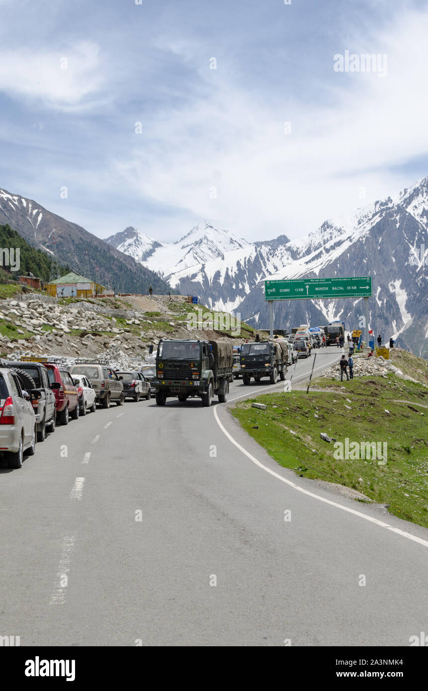 Tourist taxis patiently wait in queue as Indian Army convoy of trucks ...