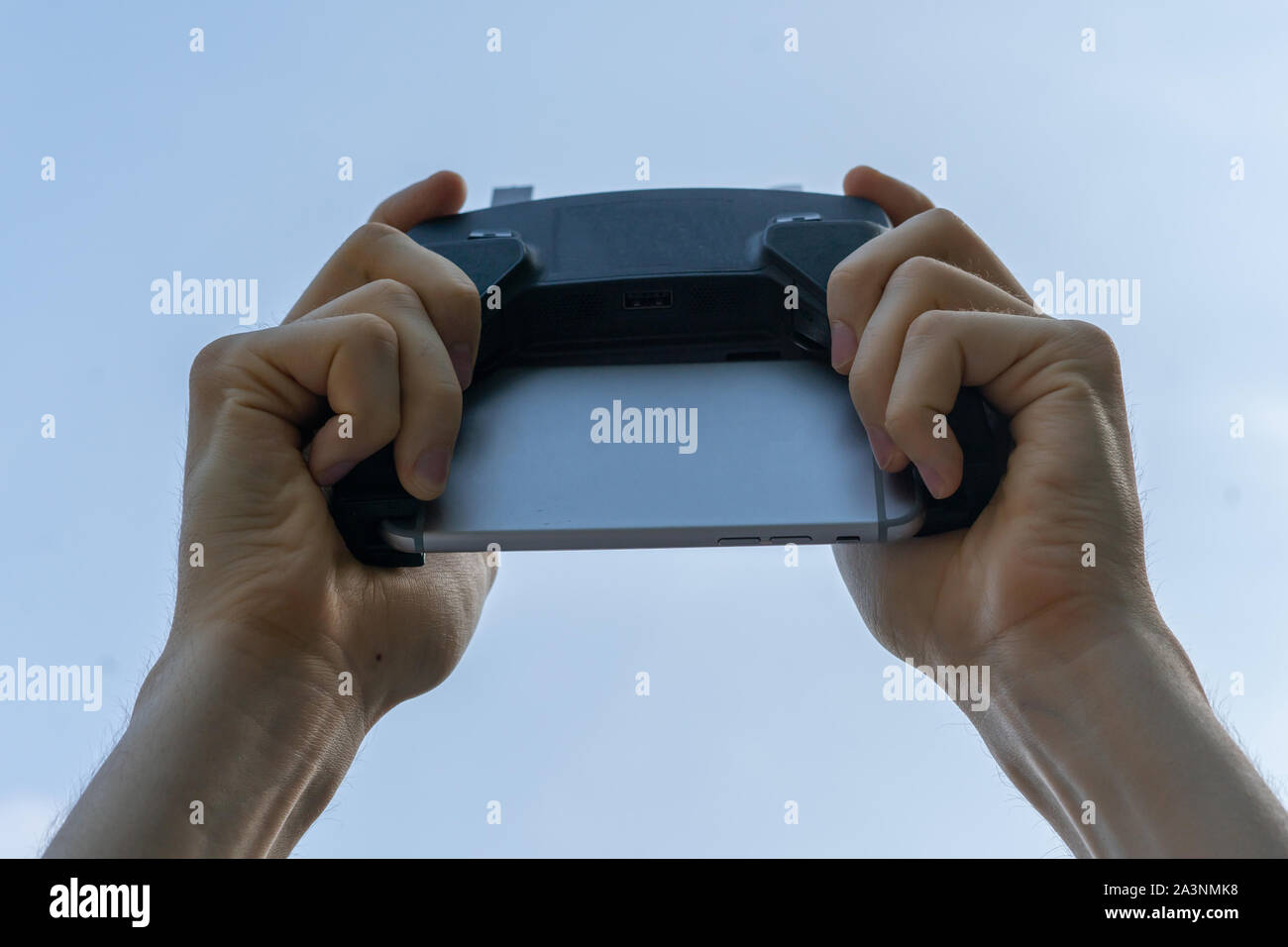 person holding a wireless gadget remote control with joystick and ...