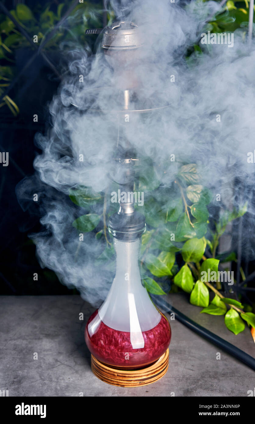 fragrant hookah in the smoke on the table Stock Photo - Alamy
