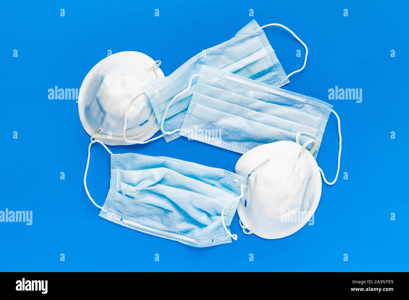 simple white air protection mask on the color surface s Stock Photo - Alamy