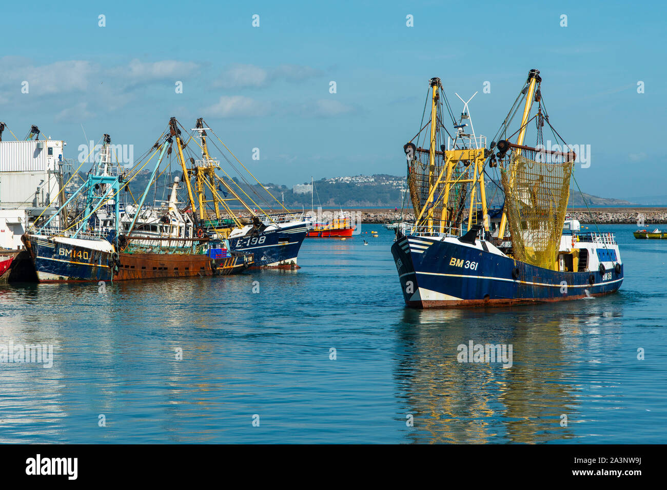 A Brixham beam trawler with nets hoisted arrives in the main harbour at ...