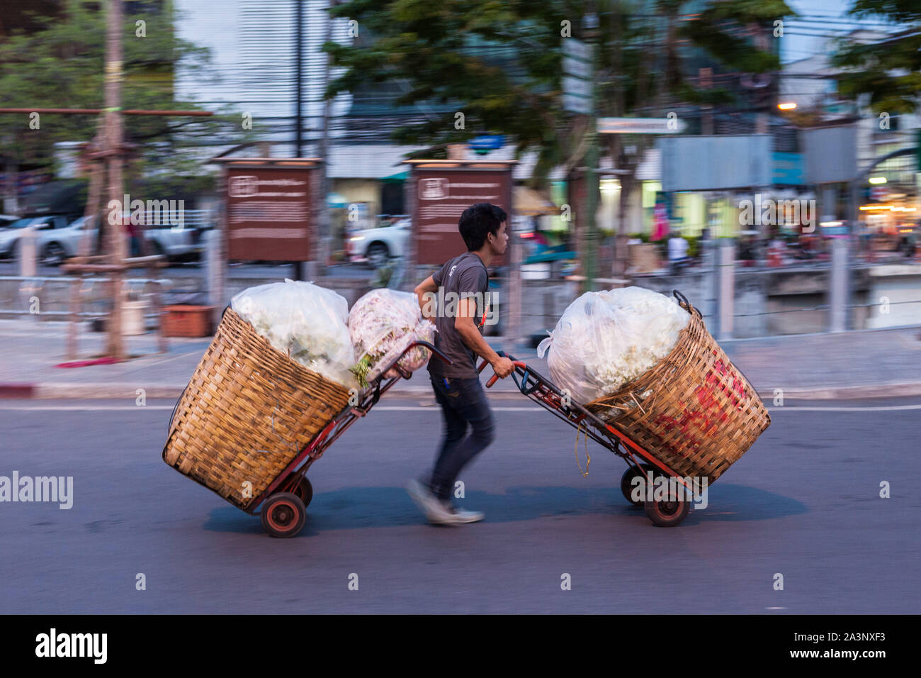 Man moving baskets in Bangkok, Thailand Stock Photo - Alamy