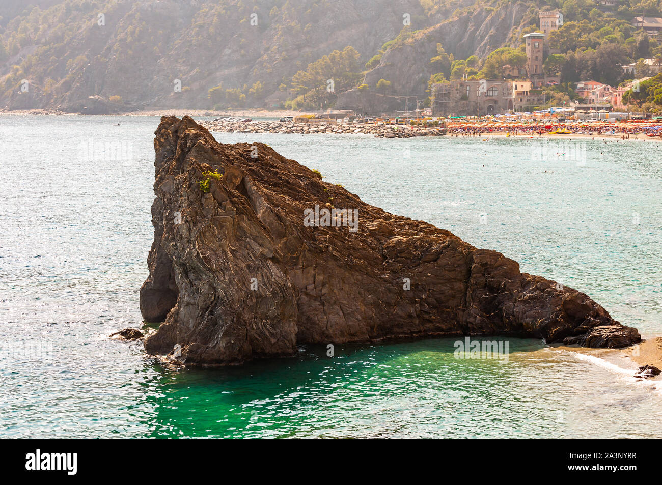 Huge triangle shape rock in the water on the beach with famous ...