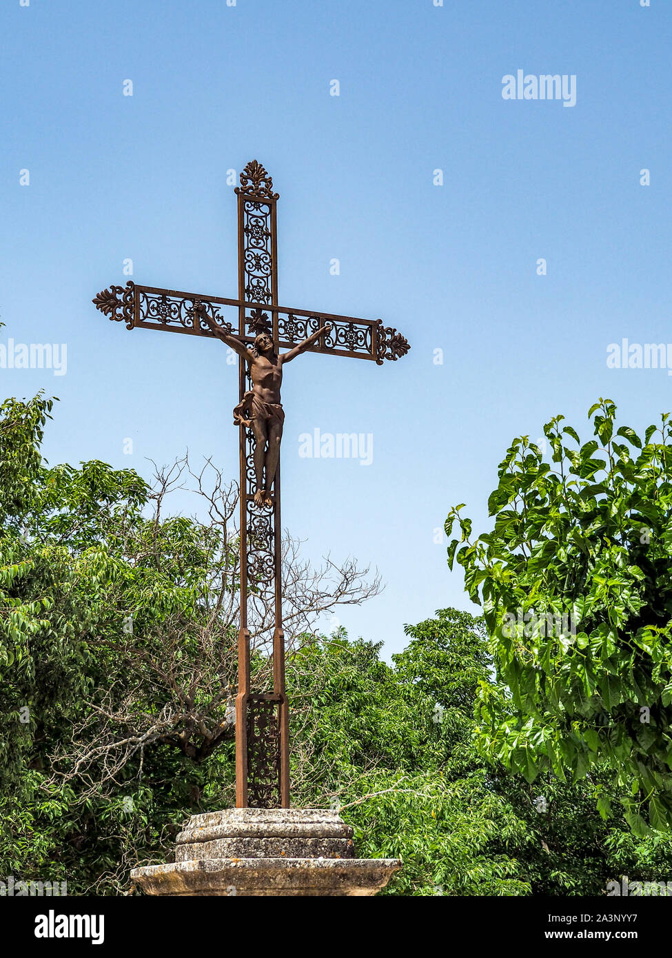 Iron crucifix with blue sky and copy space in background Stock Photo ...