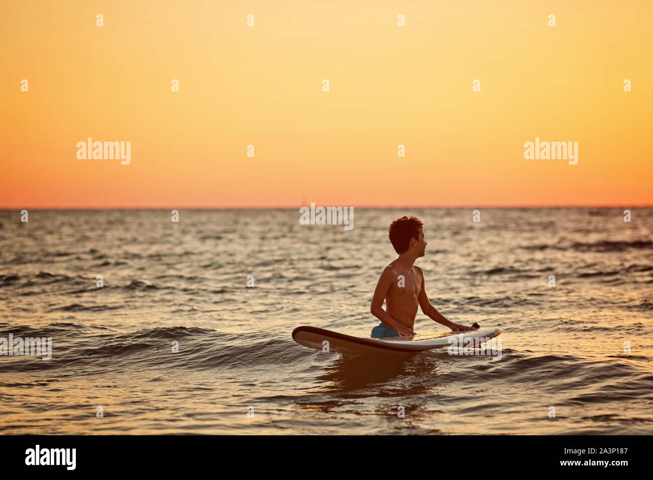 Child surfing asia hi-res stock photography and images - Alamy